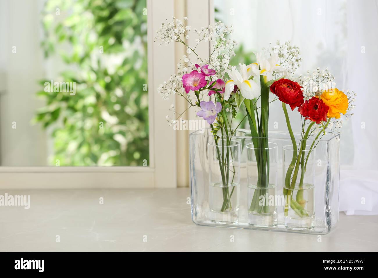 Beautiful fresh flowers on window sill indoors. Space for text Stock ...