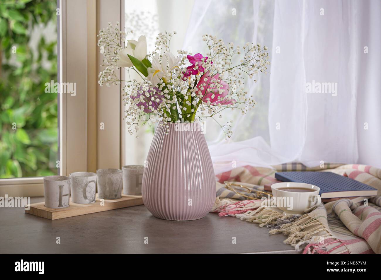 Beautiful fresh flowers on window sill indoors Stock Photo - Alamy