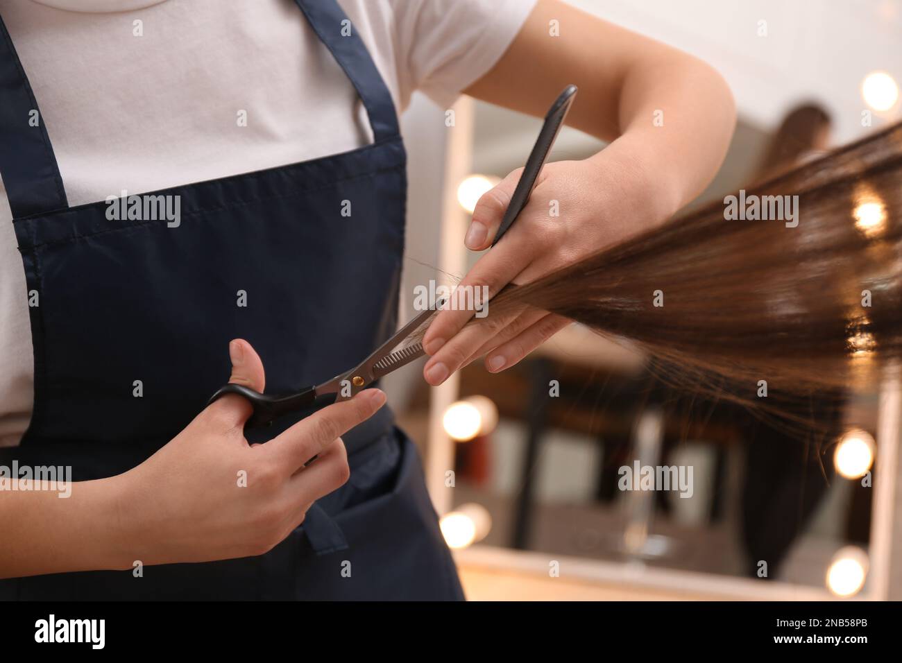 Stylist cutting hair of client in professional salon, closeup Stock ...