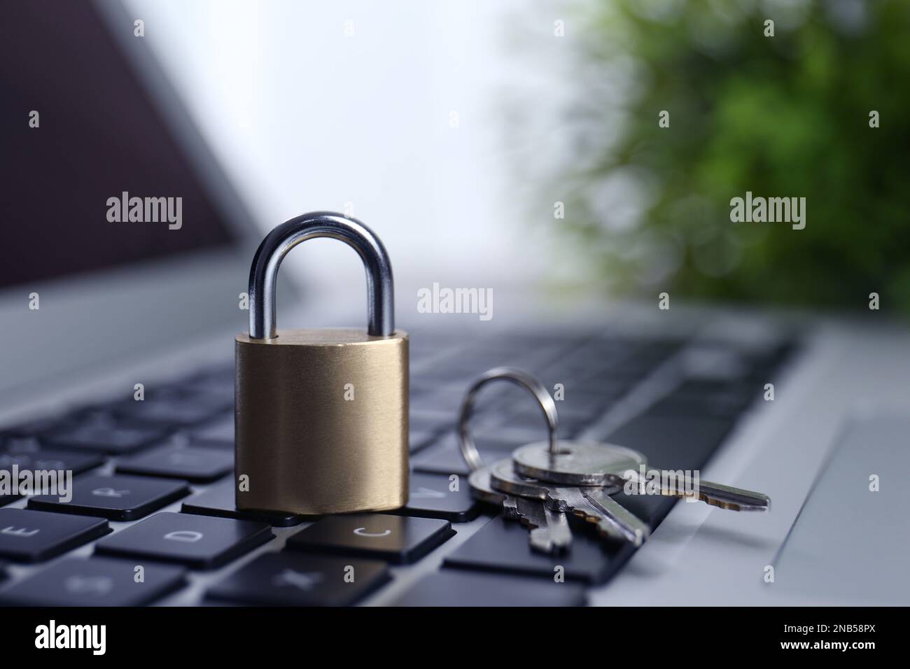 Metal padlock and keys on laptop keyboard, space for text. Cyber ...
