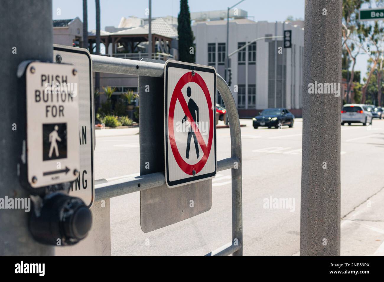 Cross Walk Sign With Cars Driving in the Background Stock Photo - Alamy