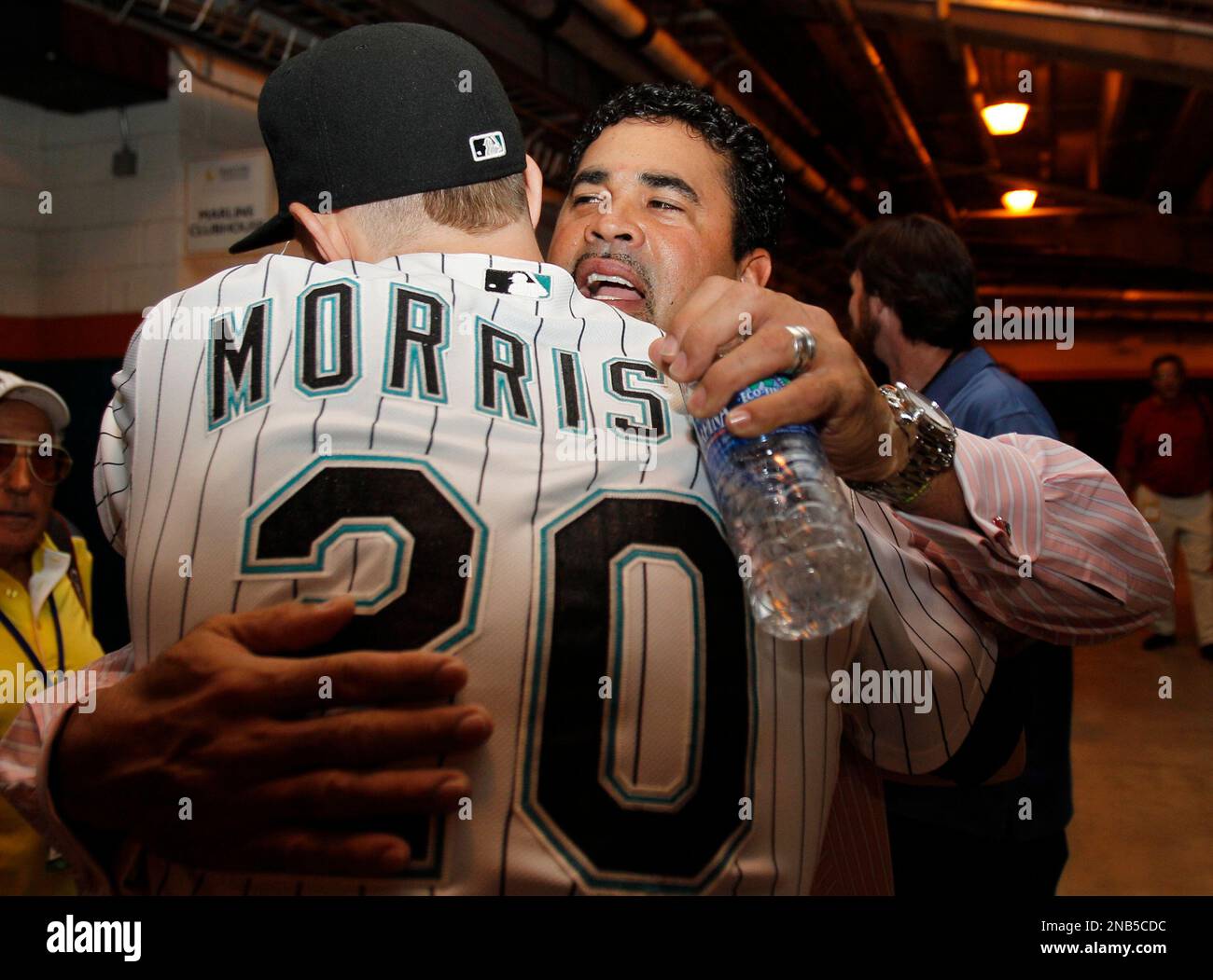 New Florida Marlins manager Ozzie Guillen, right, hugs Florida Marlins ...