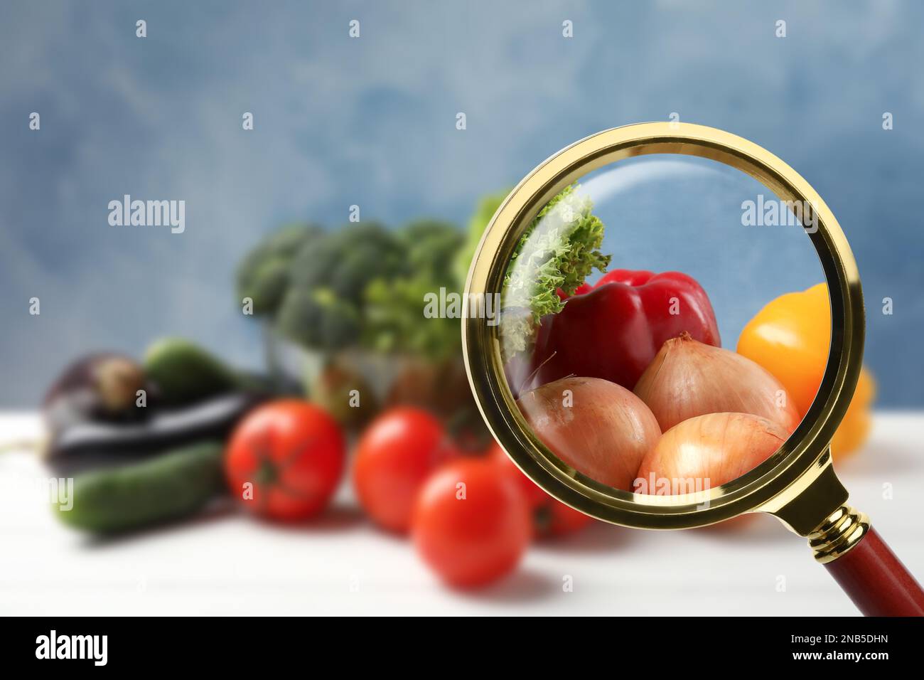 View through magnifying glass on vegetables, closeup. Poison detection ...