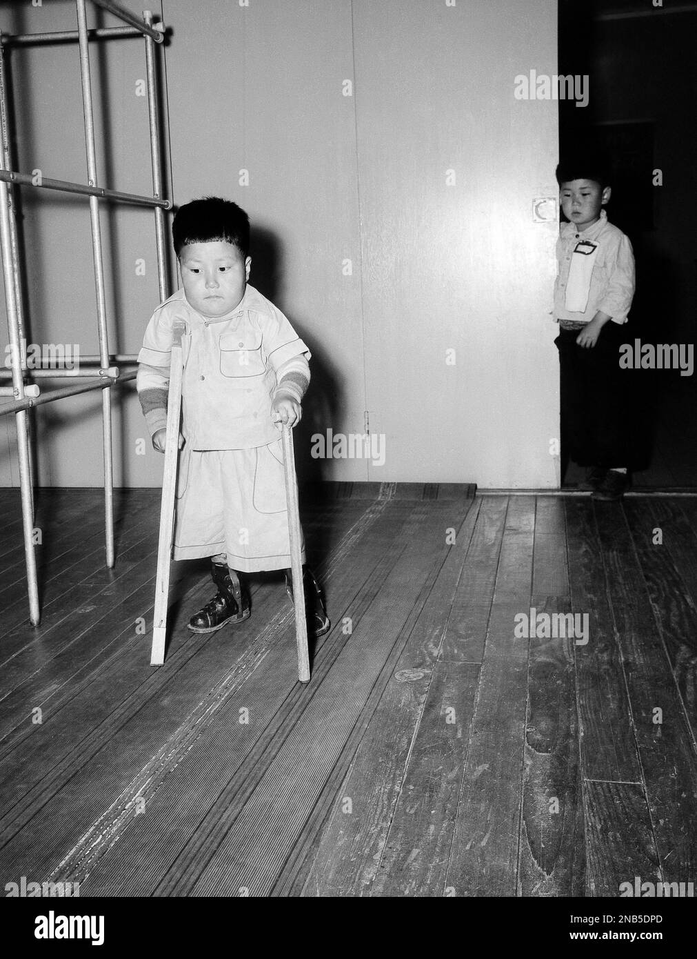 Chung Yung Jin, 5, a polio victim, taking walking exercises at National ...