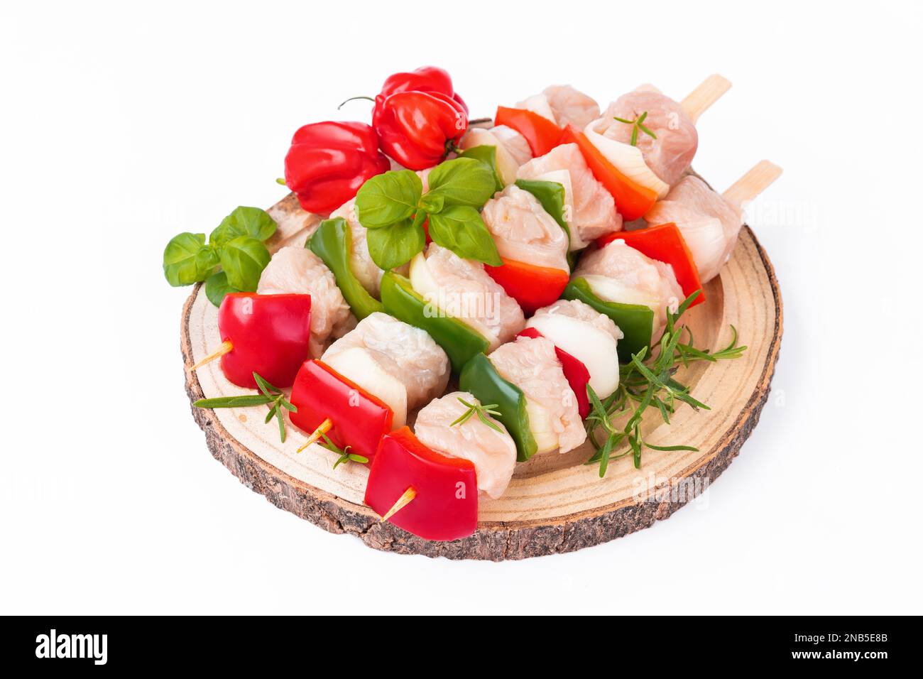 Raw turkey skewers with vegetables,peppers,onions white background ...