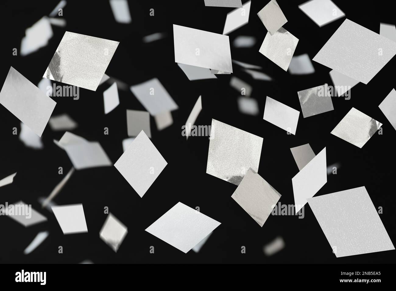 White confetti falling down on black background Stock Photo - Alamy