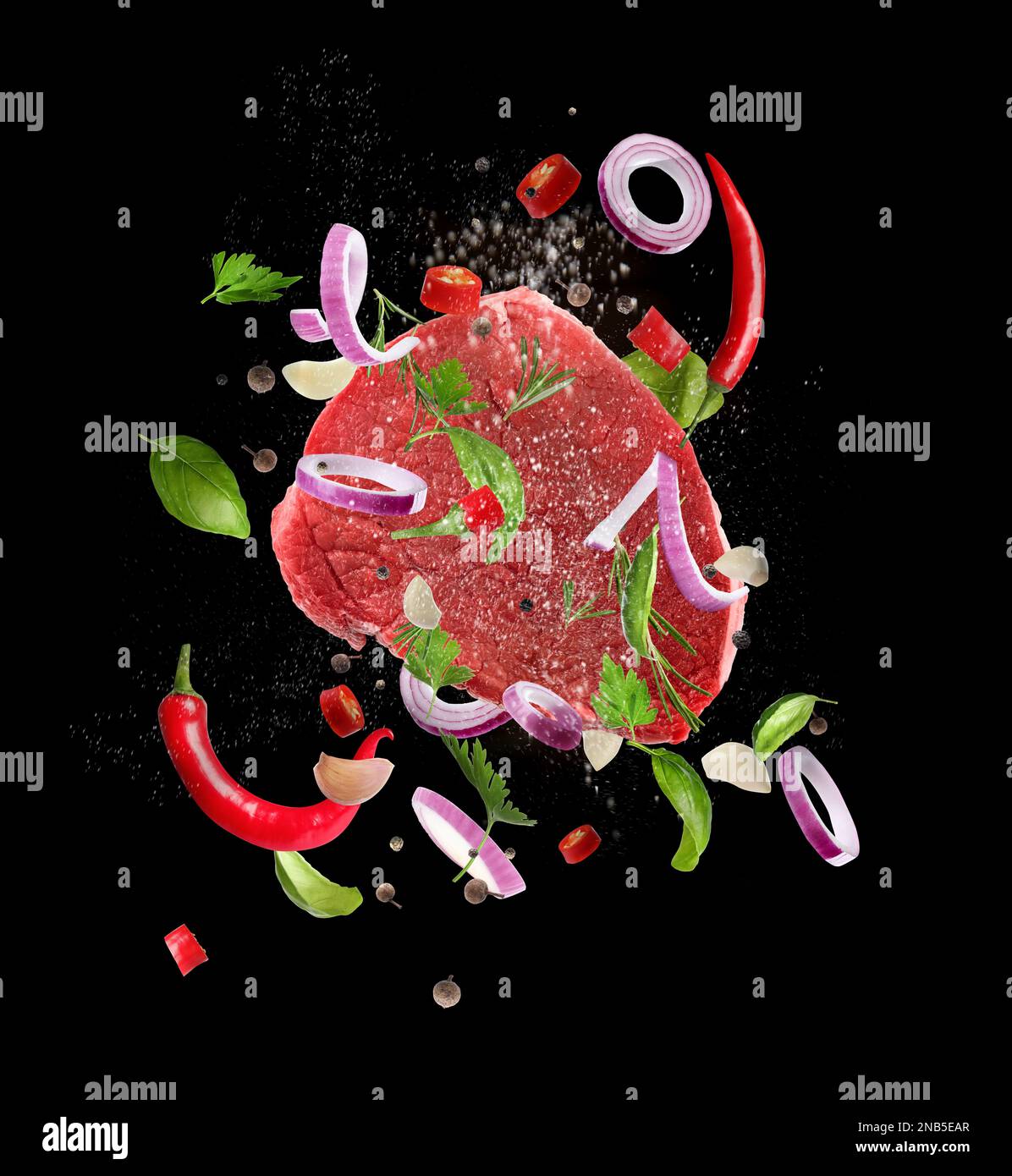 Fresh raw meat and different spices flying on black background Stock ...