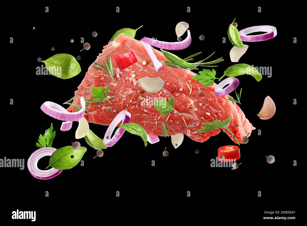 Fresh raw meat and different spices flying on black background Stock ...