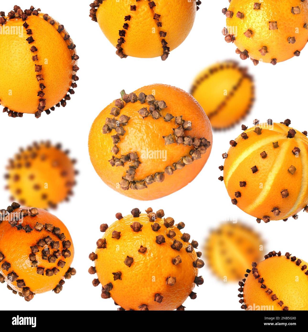 Different pomander balls made of fresh tangerines and cloves falling on ...