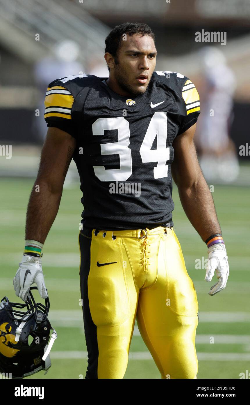 Iowa running back Marcus Coker stands on the field before an NCAA ...