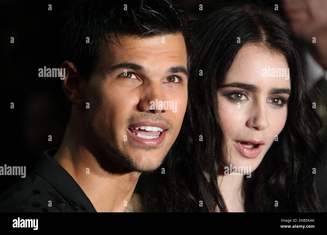 Actors Taylor Lautner, left, and Lily Collins, arrive on the red carpet ...