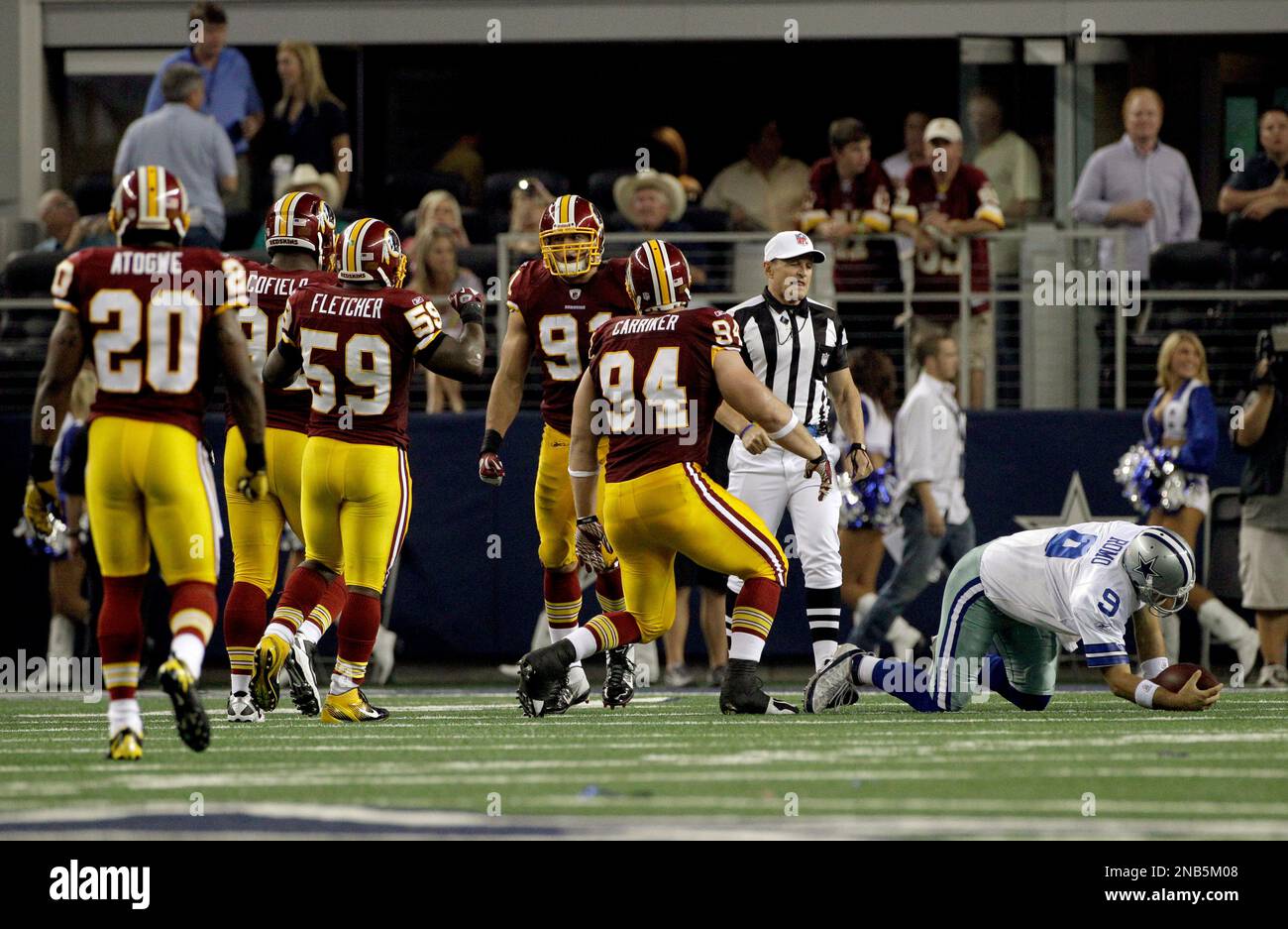 Dallas Cowboys quarterback Tony Romo is slow to get up after a tackle ...