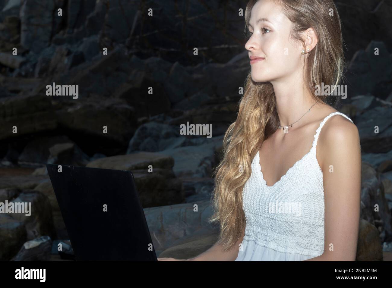 remotely on the laptop in beach. Working remotely on the laptop ...