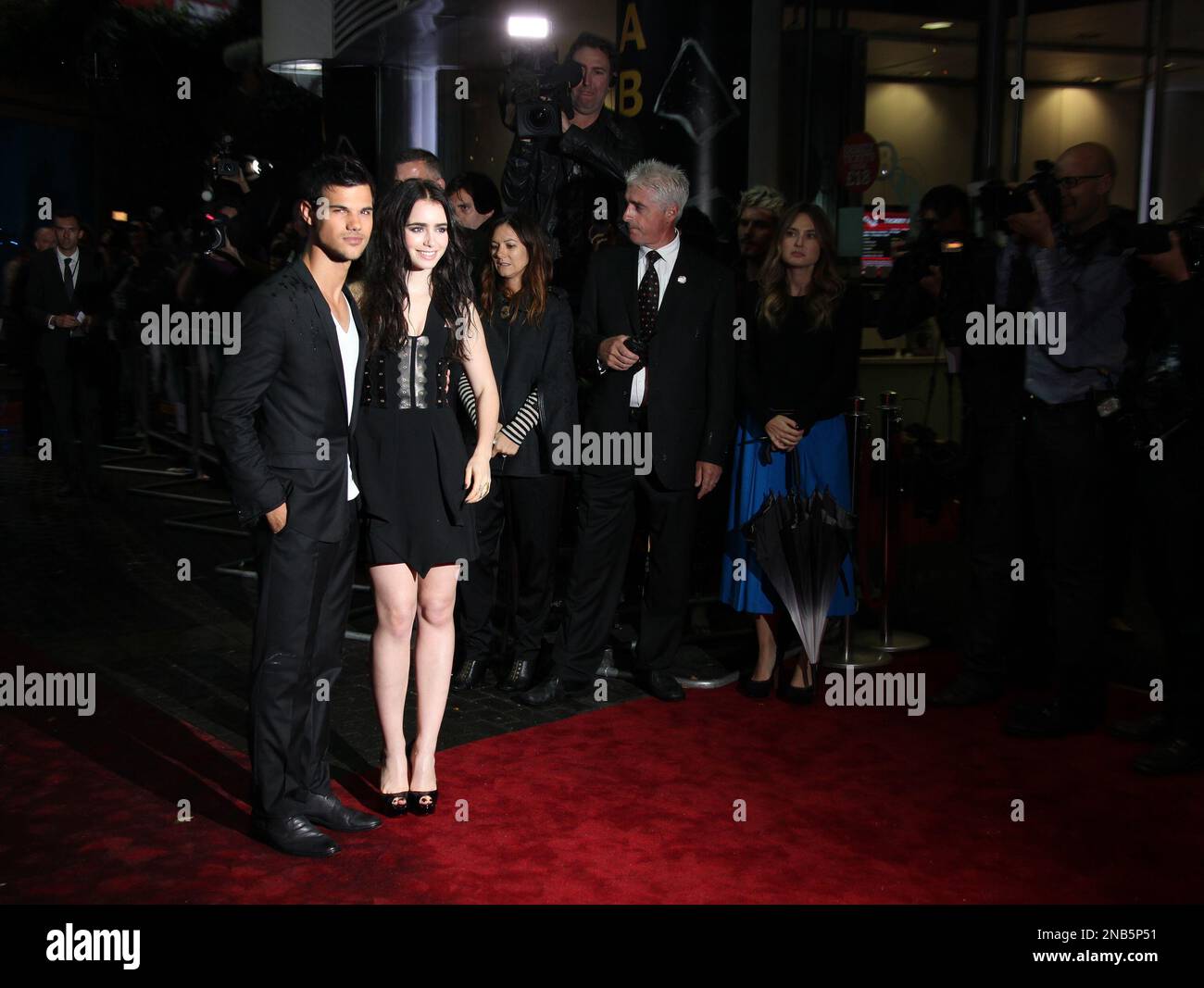 Actors Taylor Lautner, left, and Lily Collins, arrive on the red carpet ...