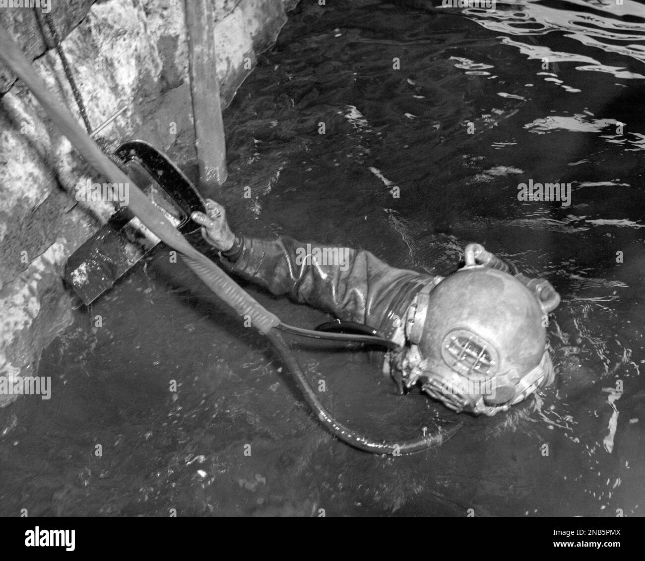 SF 2/c Edward Puckett, of Murphysboro, Tenn., sends up an ingot of ...