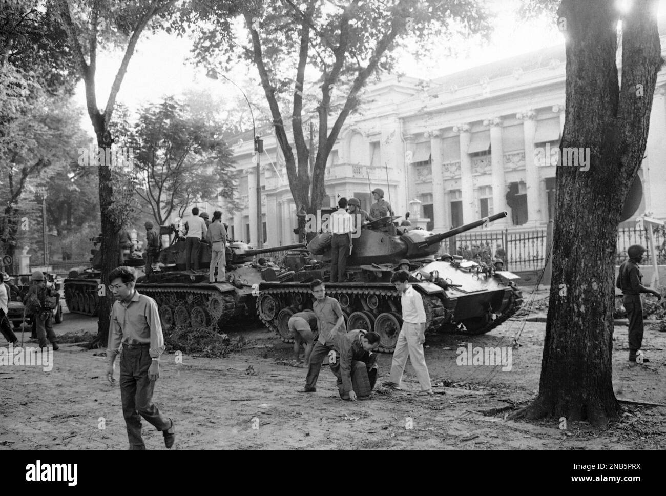Rebel tanks are drawn up in front of the presidential palace in Saigon ...