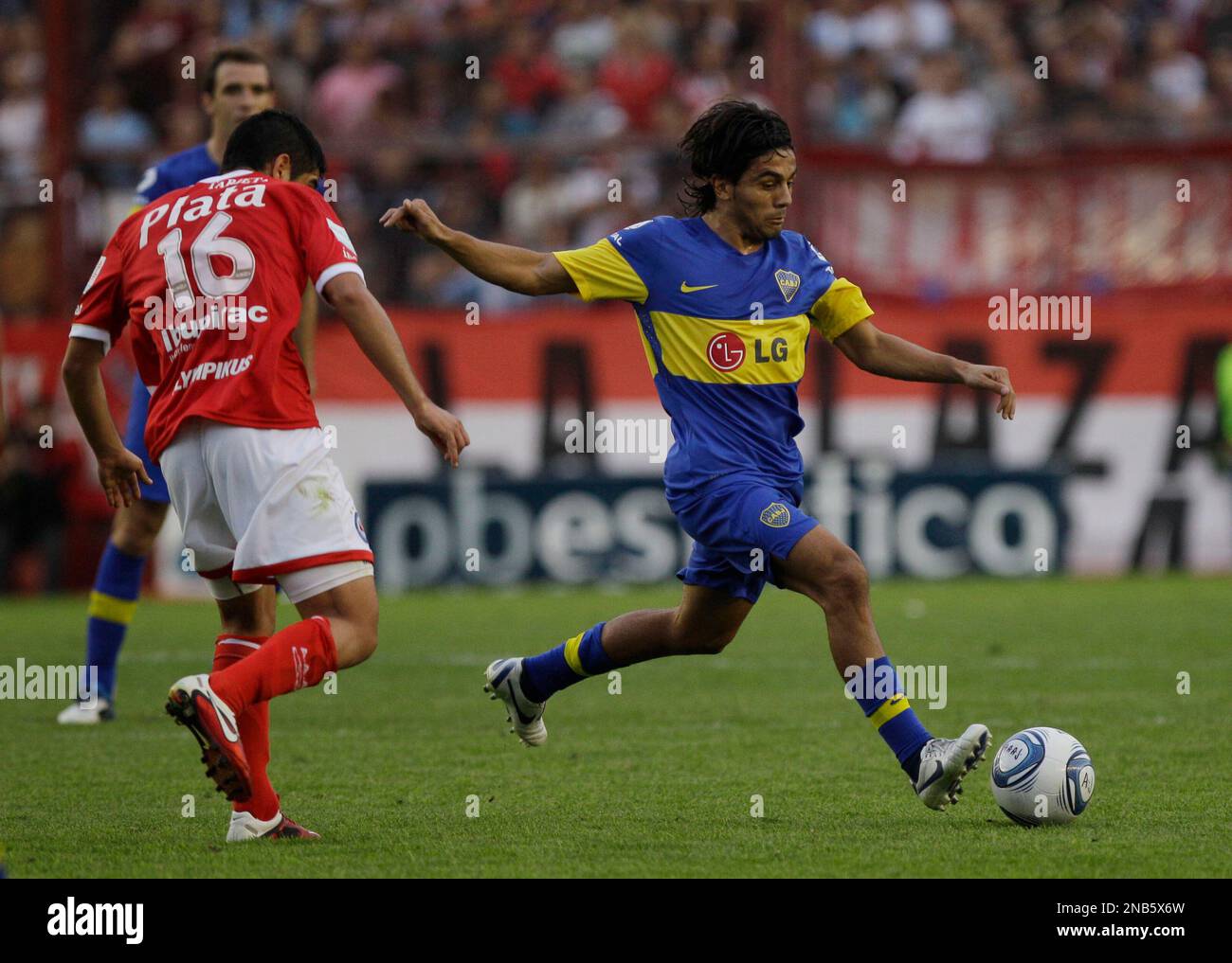Boca Juniors' Walter Erviti, right, plays the ball as Argentinos ...