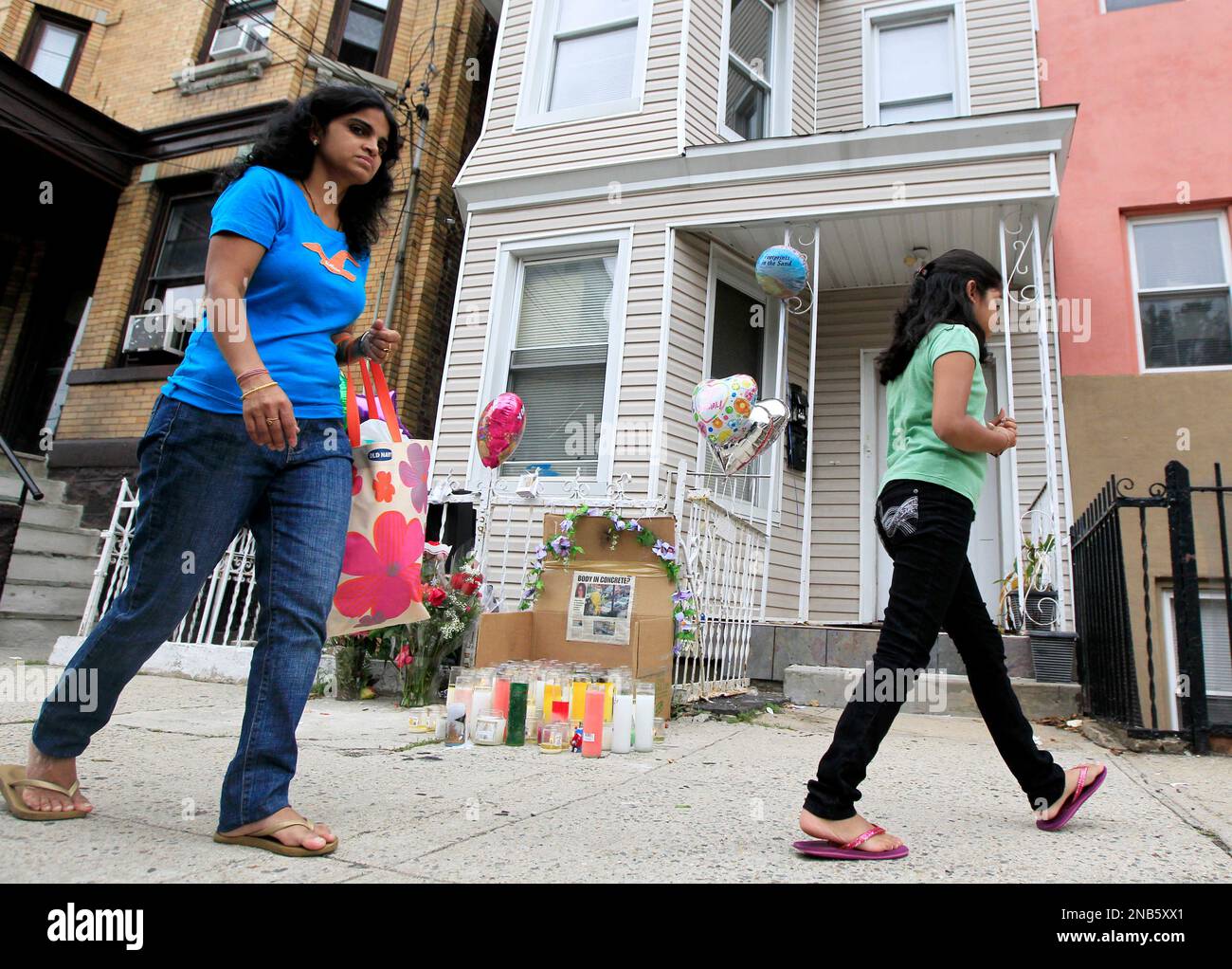 People walk by a makeshift memorial for Randy "Amanda" Lehrer in front ...