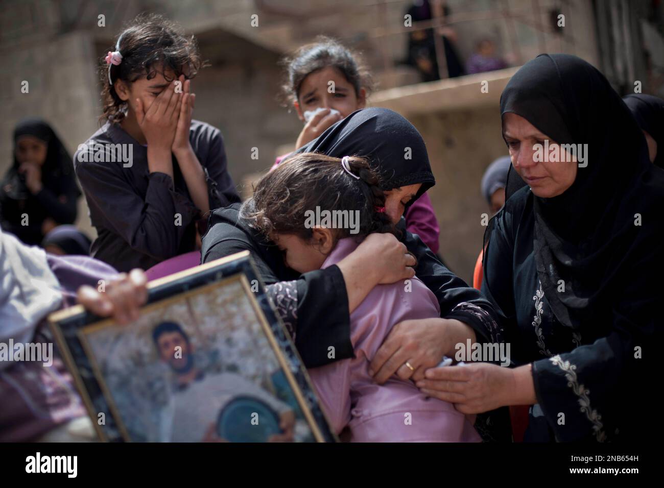 Palestinian Samir Badran, center, embraces one of her daughters during ...