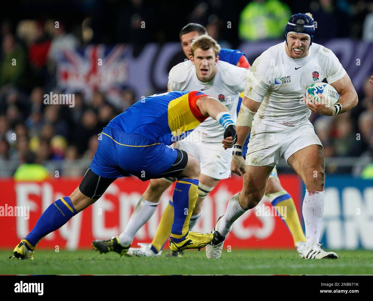 England's James Haskell, right, runs at Romania's Mihai Macovei ...