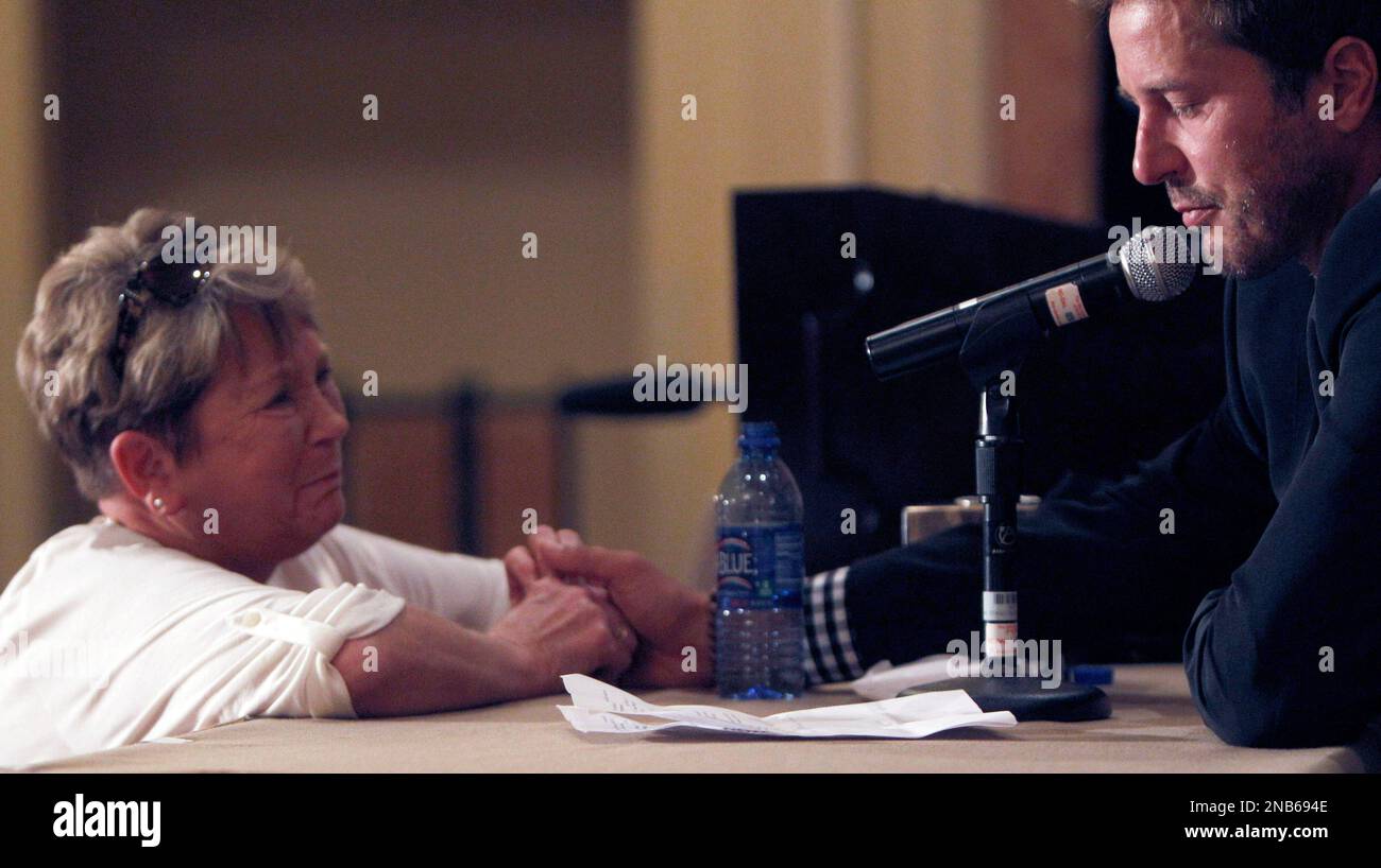 Former NHL hockey player Mike Modano, right, gets some comfort from his ...
