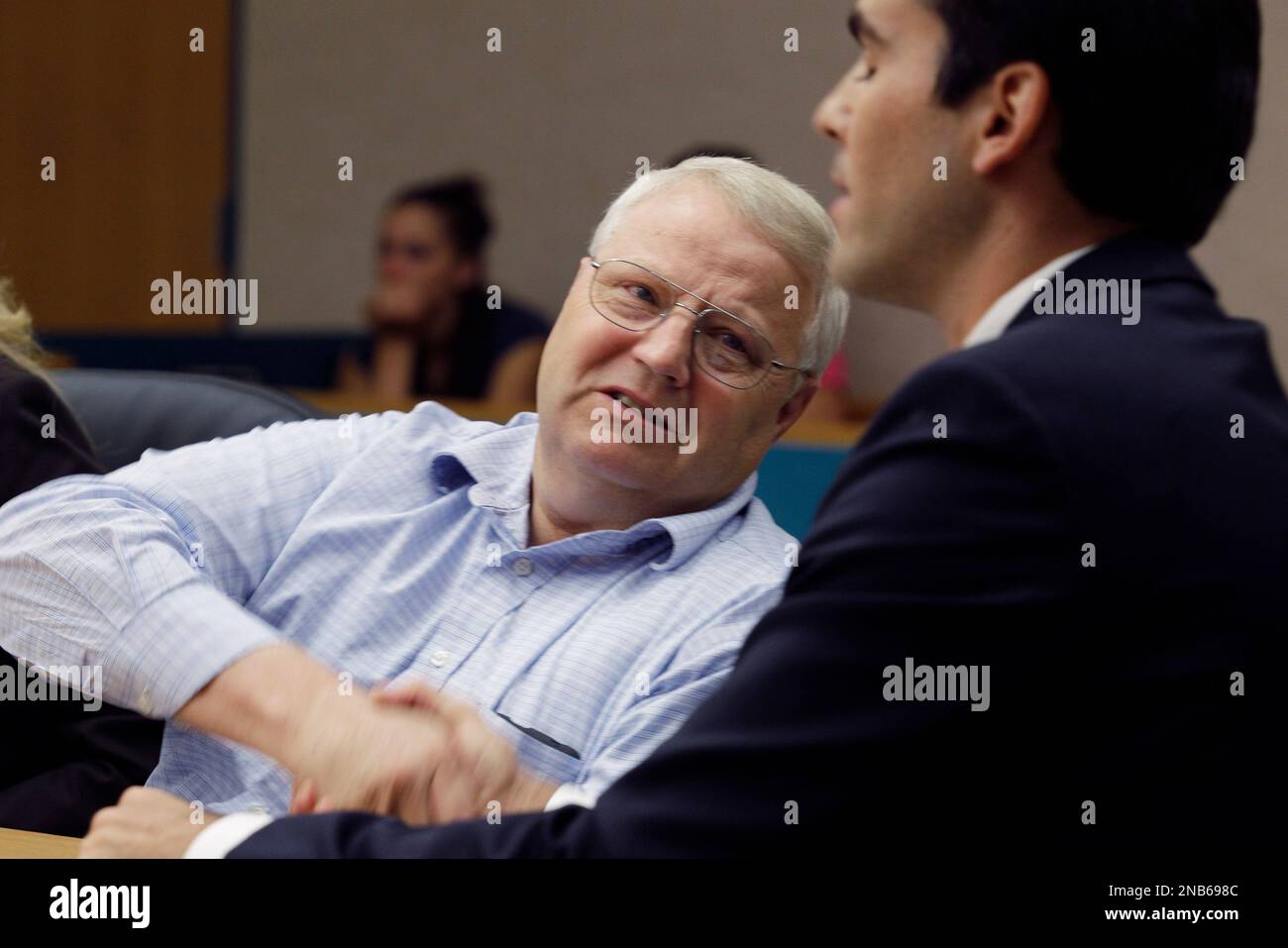 Chuck Cox, left, the father of missing Utah woman Susan Powell, shakes ...