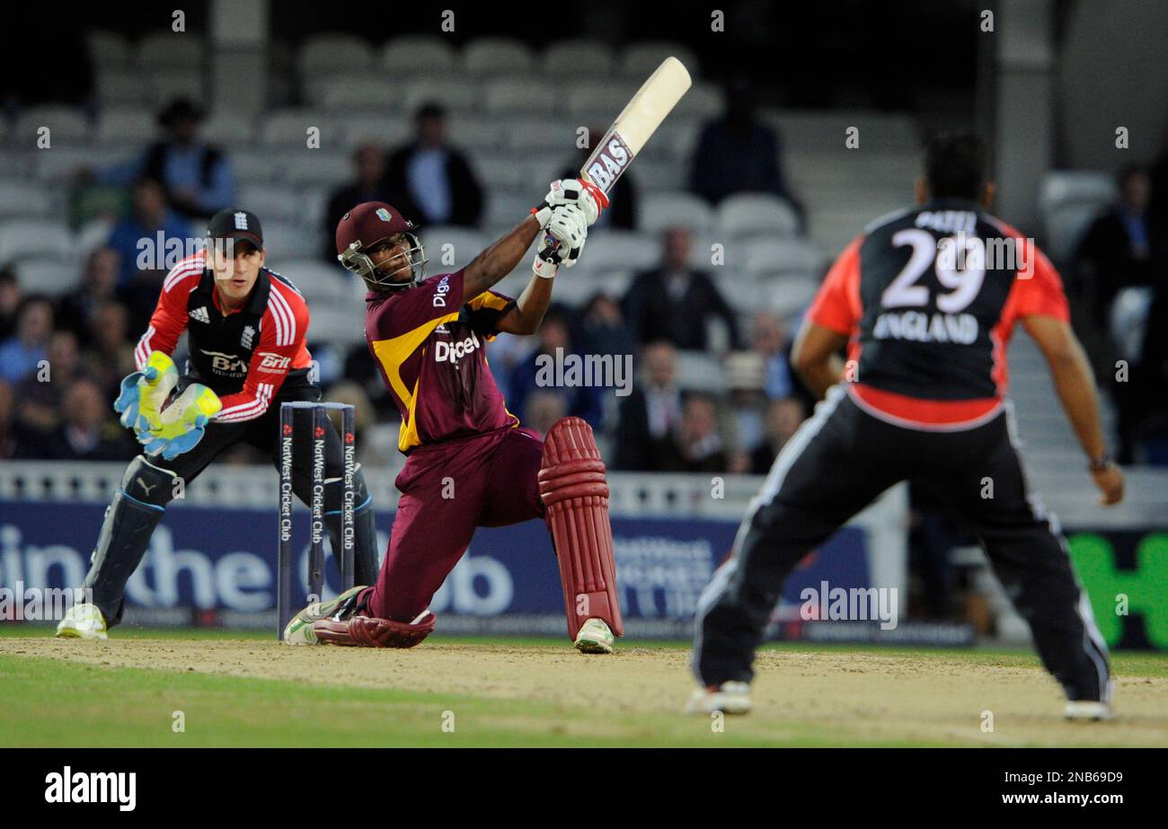 West Indies' Johnson Charles, centre, hits a ball from England's Ravi ...