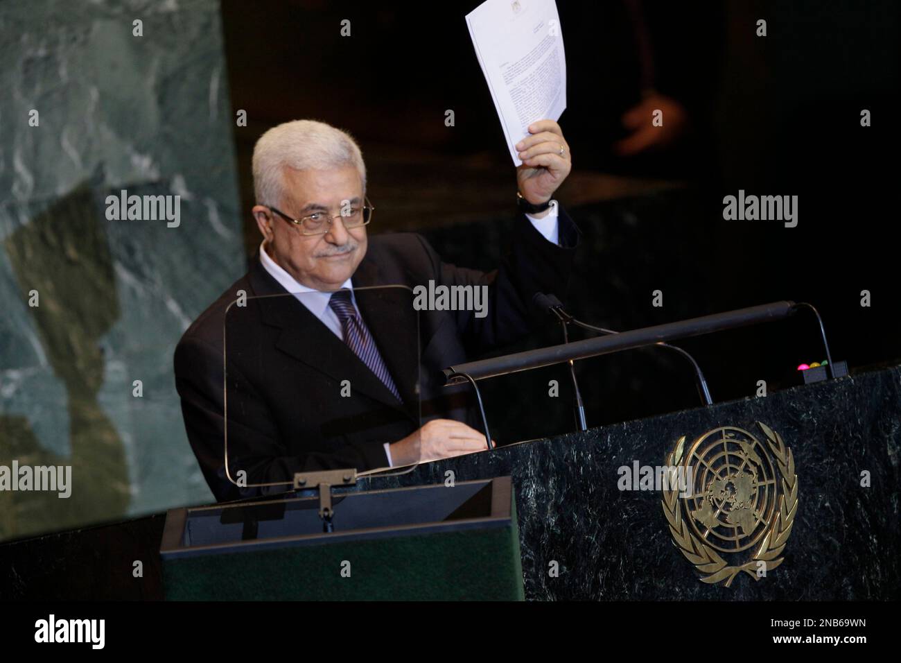 Palestinian President Mahmoud Abbas holds a letter requesting ...