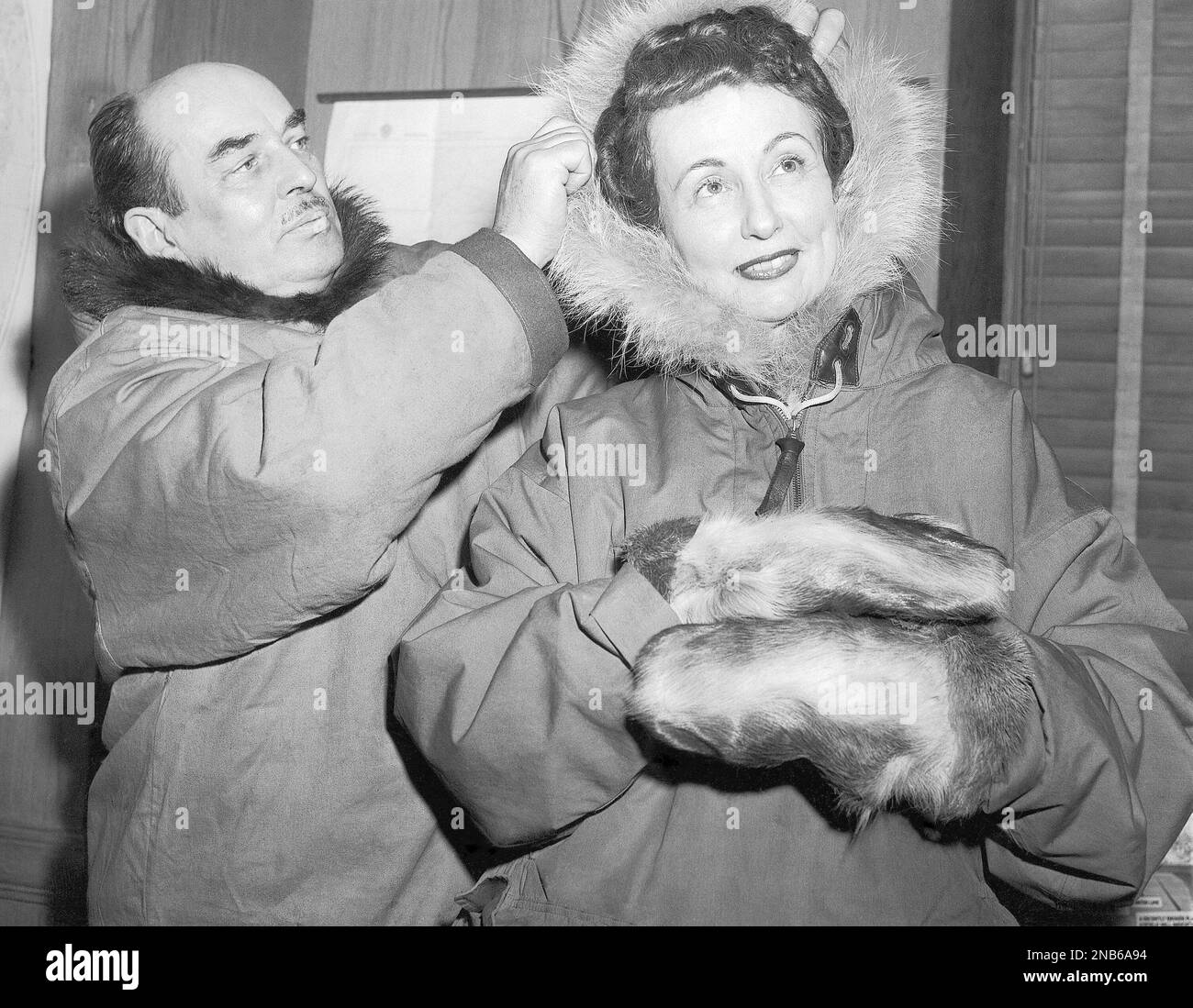 Col. John F. Stanwell-Fletcher, arctic explorer, adjusts the hood on a ...