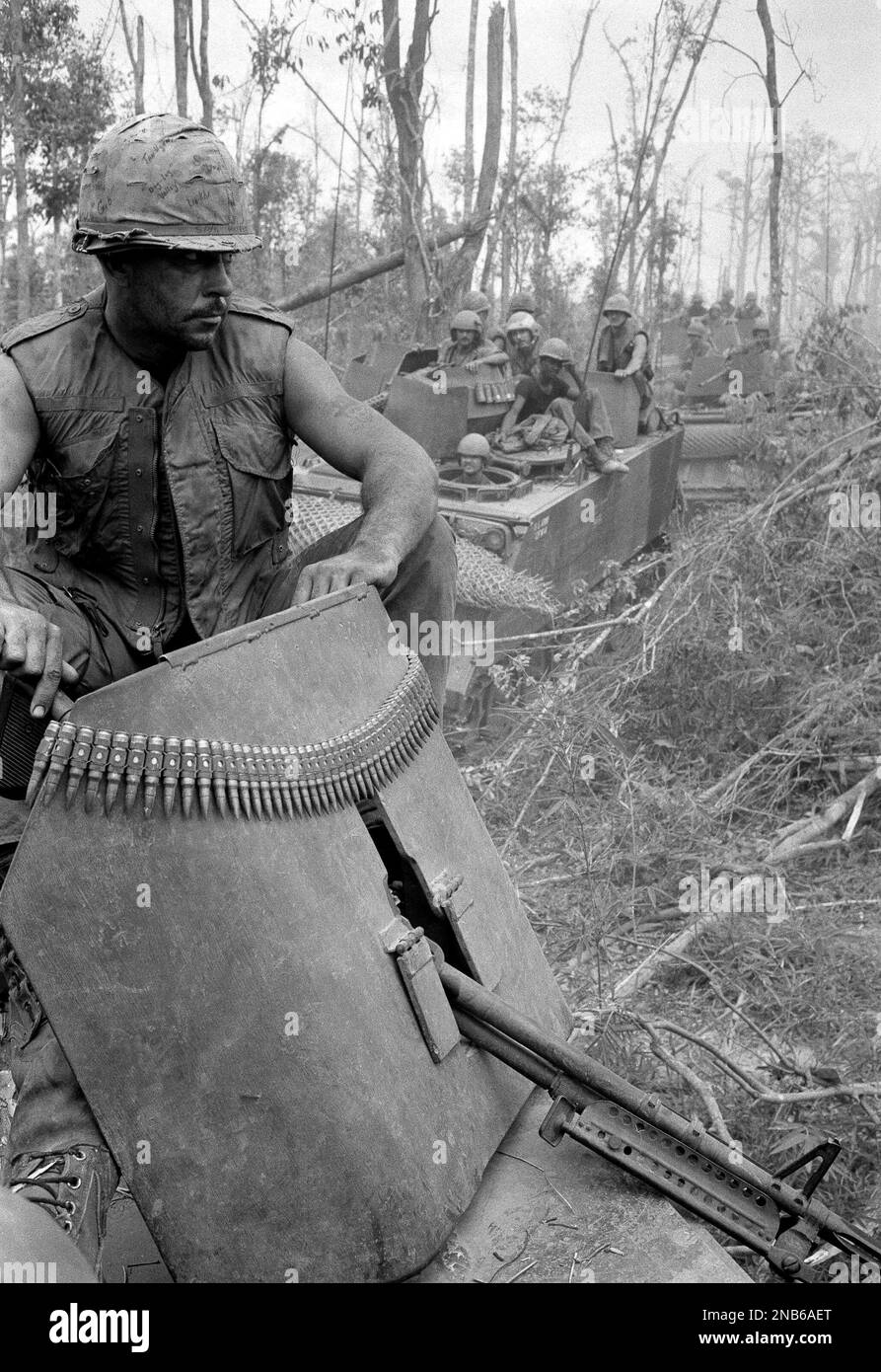 An armored personnel carrier commander leads his column through jungle ...