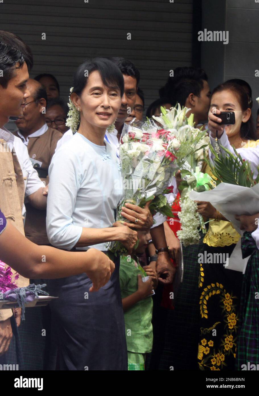 Myanmar's democracy icon Aung San Suu Kyi holds flowers as she talks ...