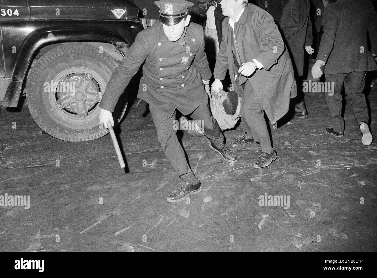 Police drag away one person from a window-smashing, store-looting crowd ...