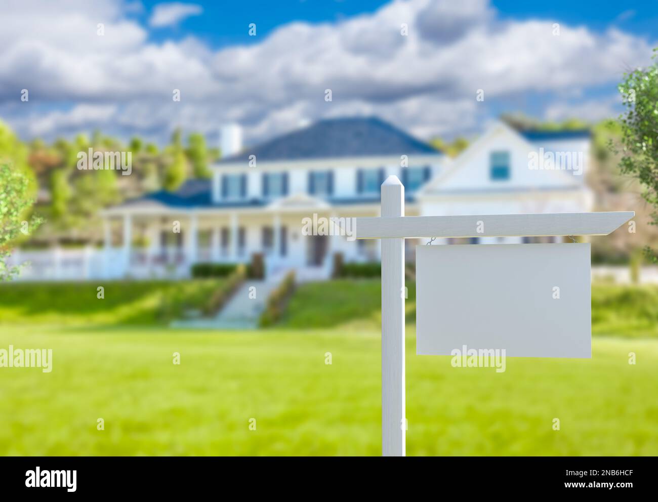 Blank Real Estate Sign in Front of New House Stock Photo - Alamy