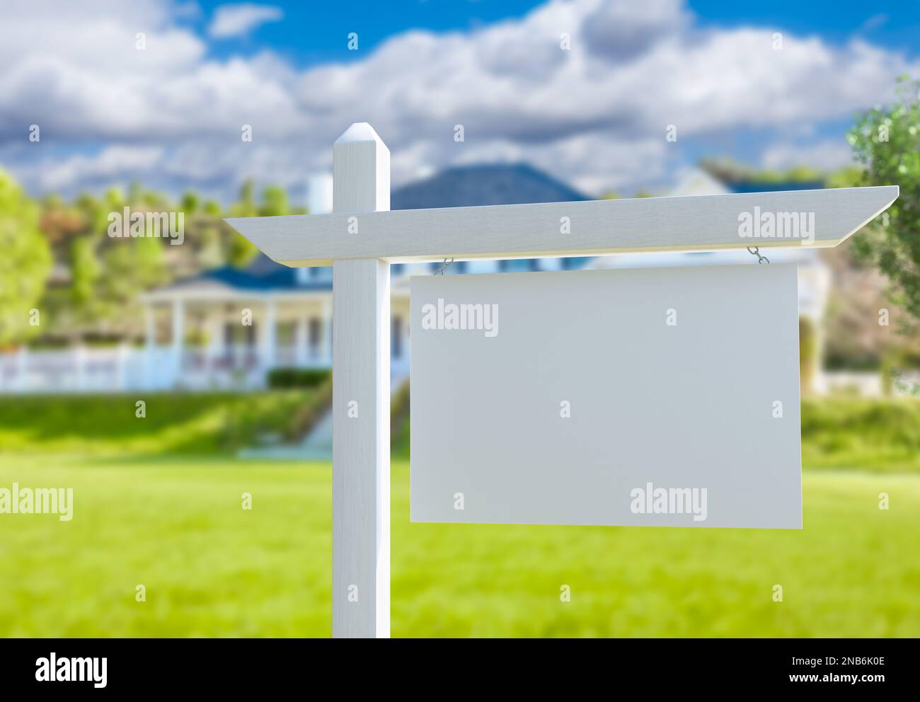 Blank Real Estate Sign in Front of New House Stock Photo - Alamy