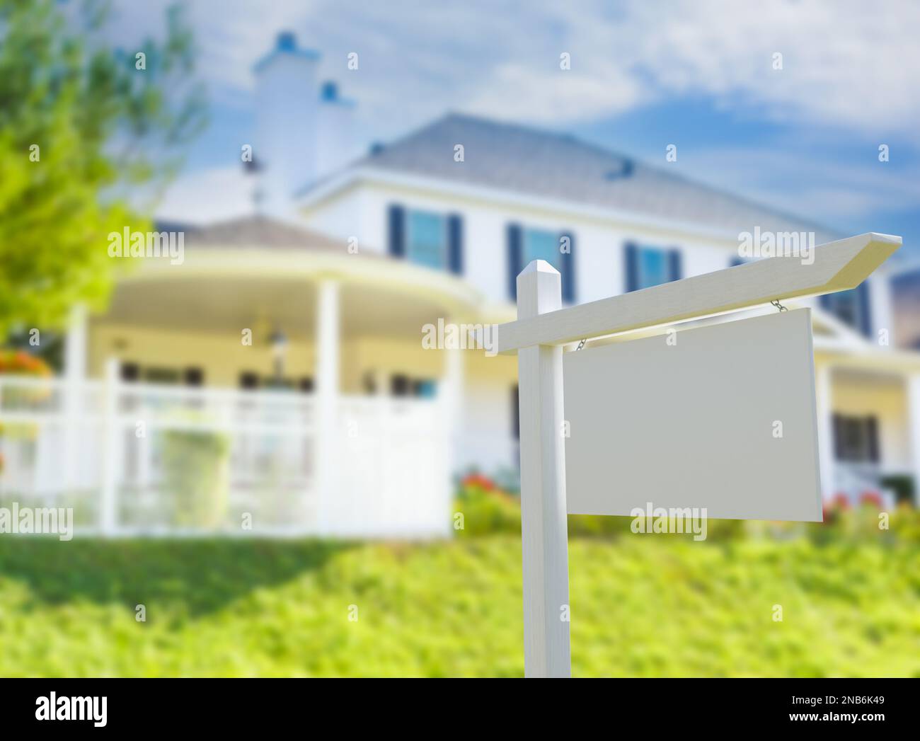 Blank Real Estate Sign in Front of New House Stock Photo - Alamy