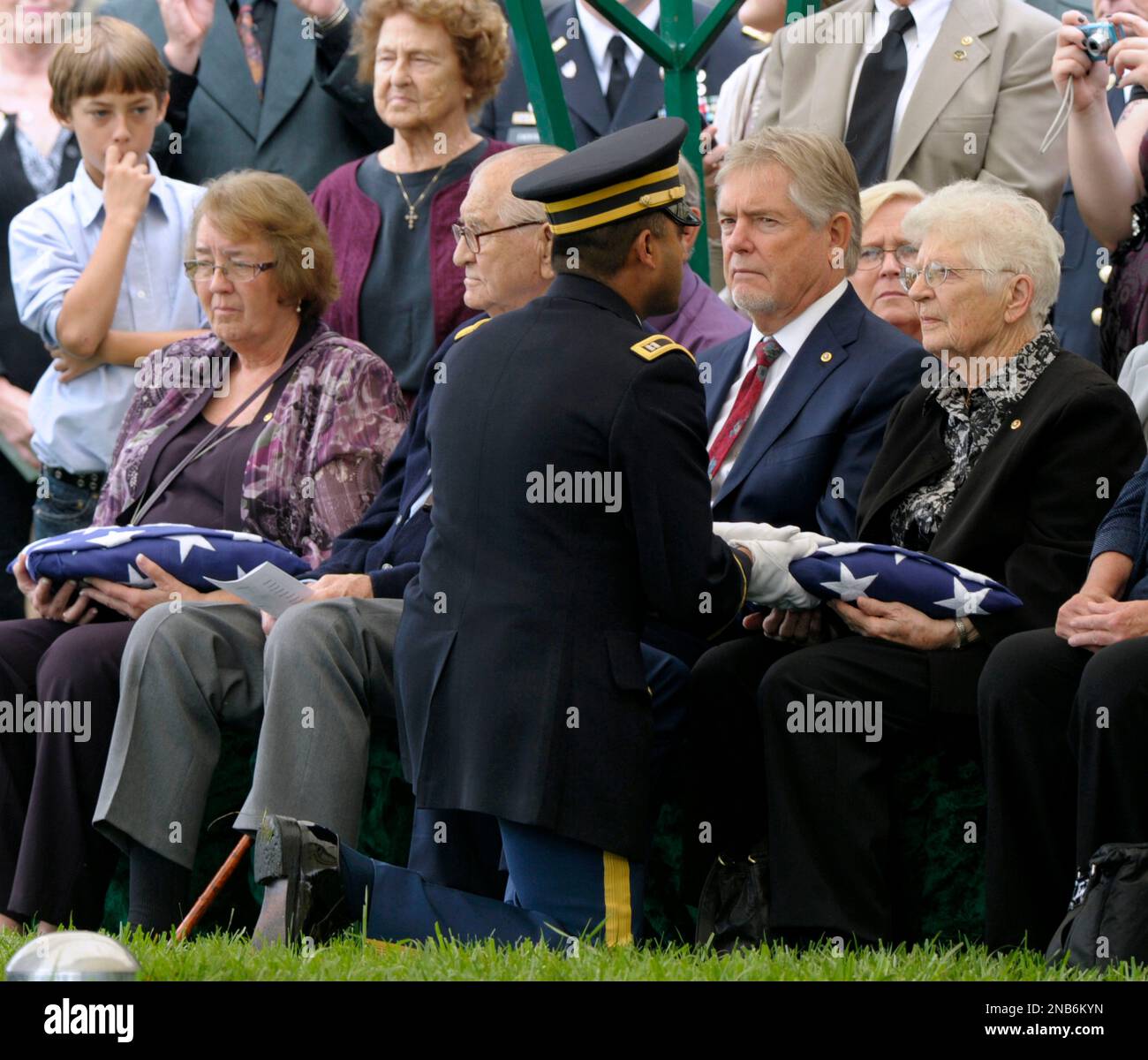 Della Edwards, widow of Tech Sgt. Leonard A Gionet, receives a flag ...