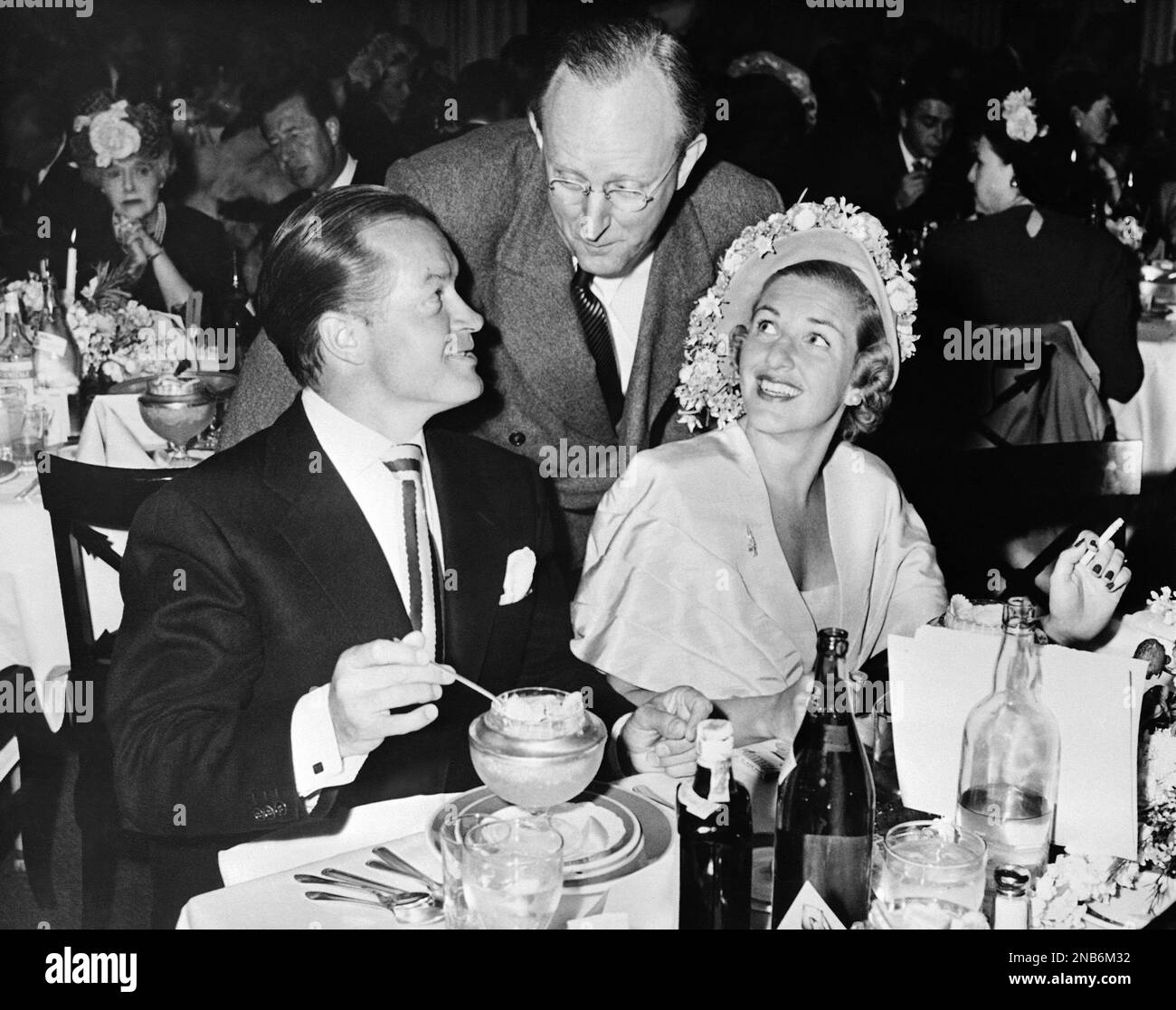 Kay Kyser, guest of honor, stops for a moment for a word with radio and ...
