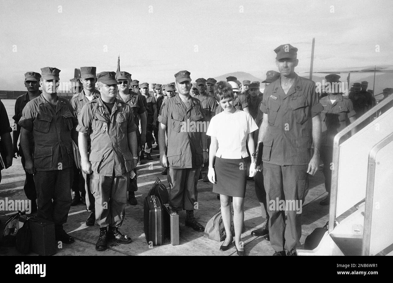 Stewardess Pat Bennett of Auburn, N.Y., stands with members of the U.S ...