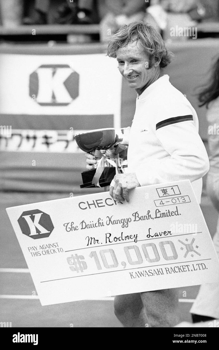 Australia’s Rod Laver holds an oversized first-prize check for $10,000 ...