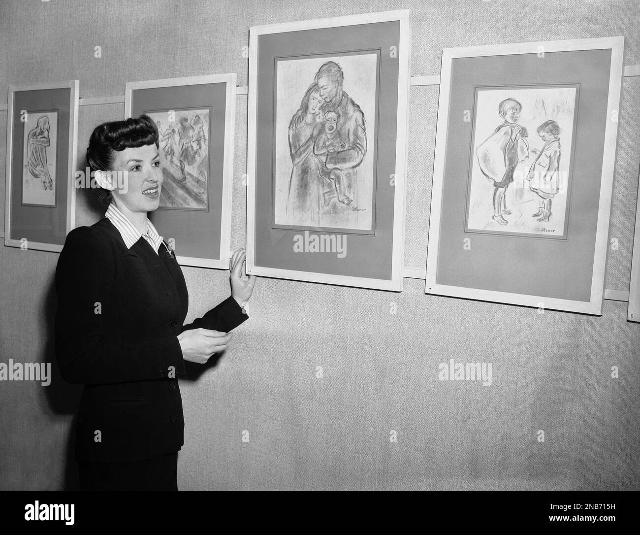 Jessica Stoner poses with her exhibition of charcoal drawings in London ...