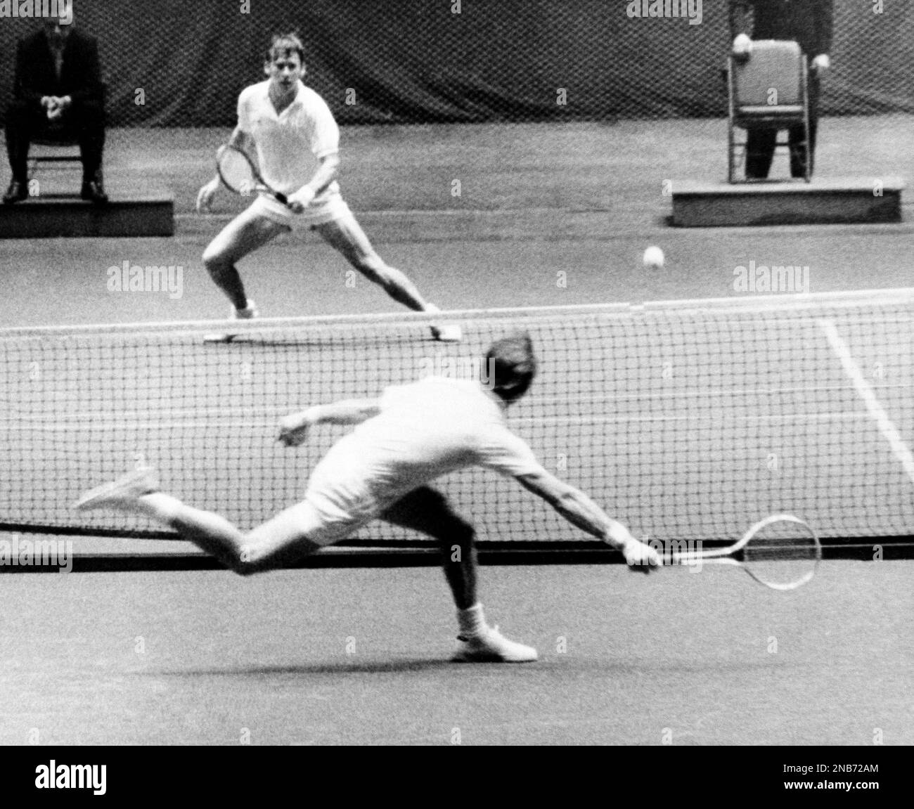 Australia’s Rod Laver, foreground, makes a big strength for ball hit by ...