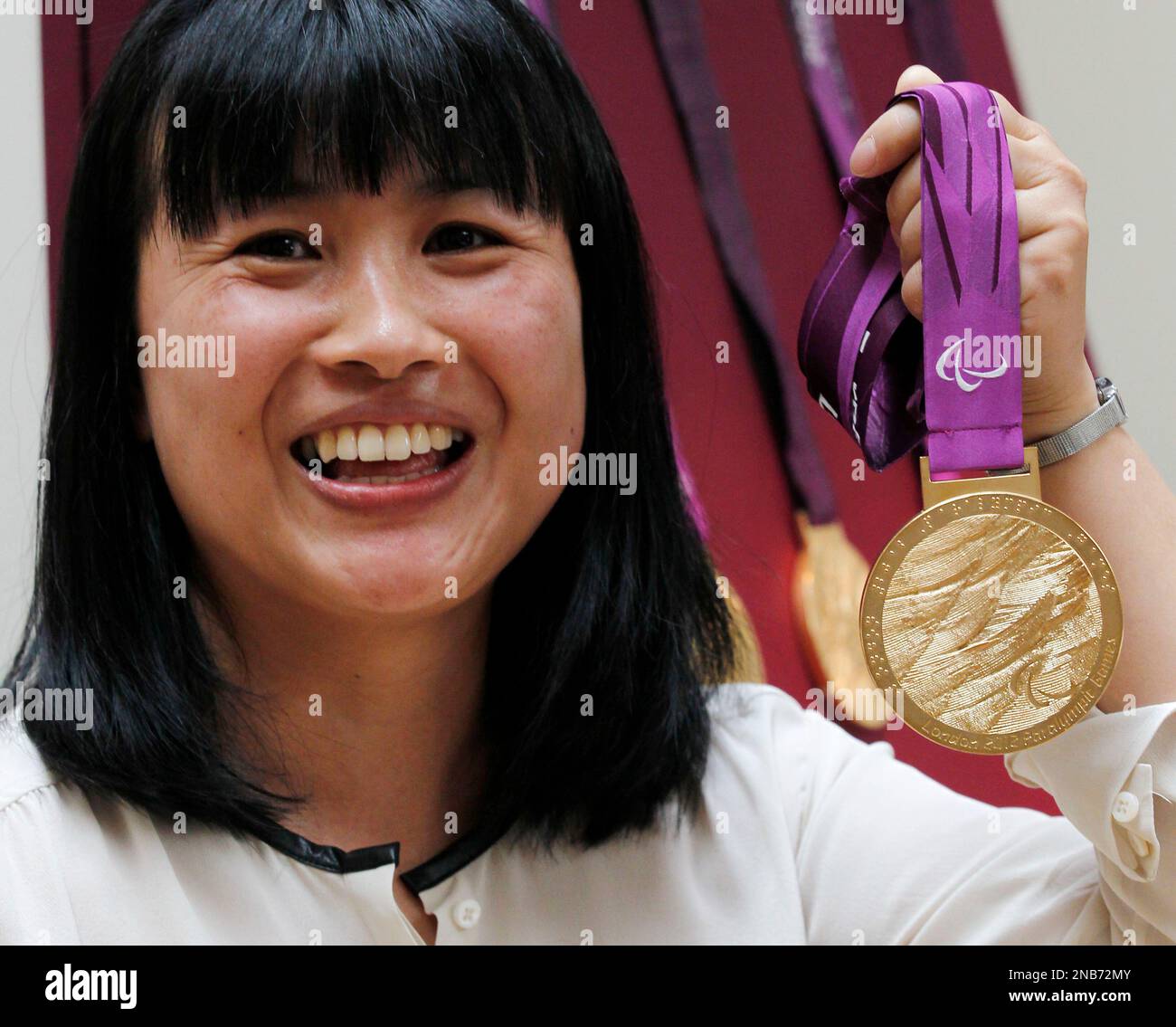 Lin Cheung, jewellery artist and the medals' designer, holds a gold ...
