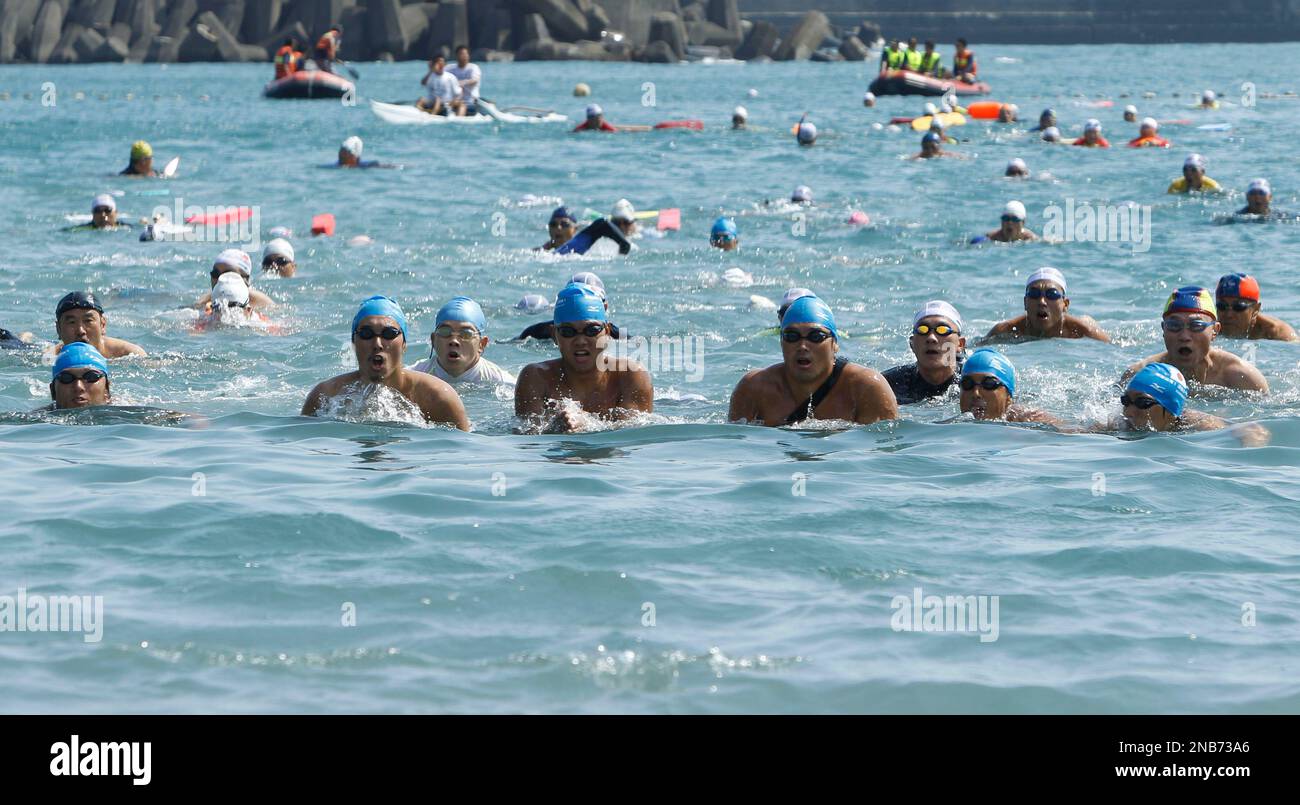 Japanese athletes swim into the Suao harbor, northeastern Taiwan ...