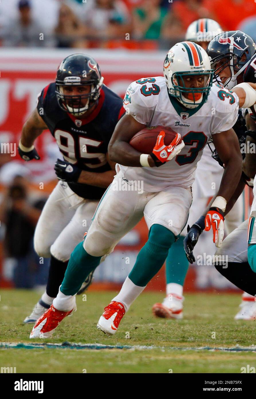 Miami Dolphins running back Daniel Thomas (33) is pursued by Houston ...