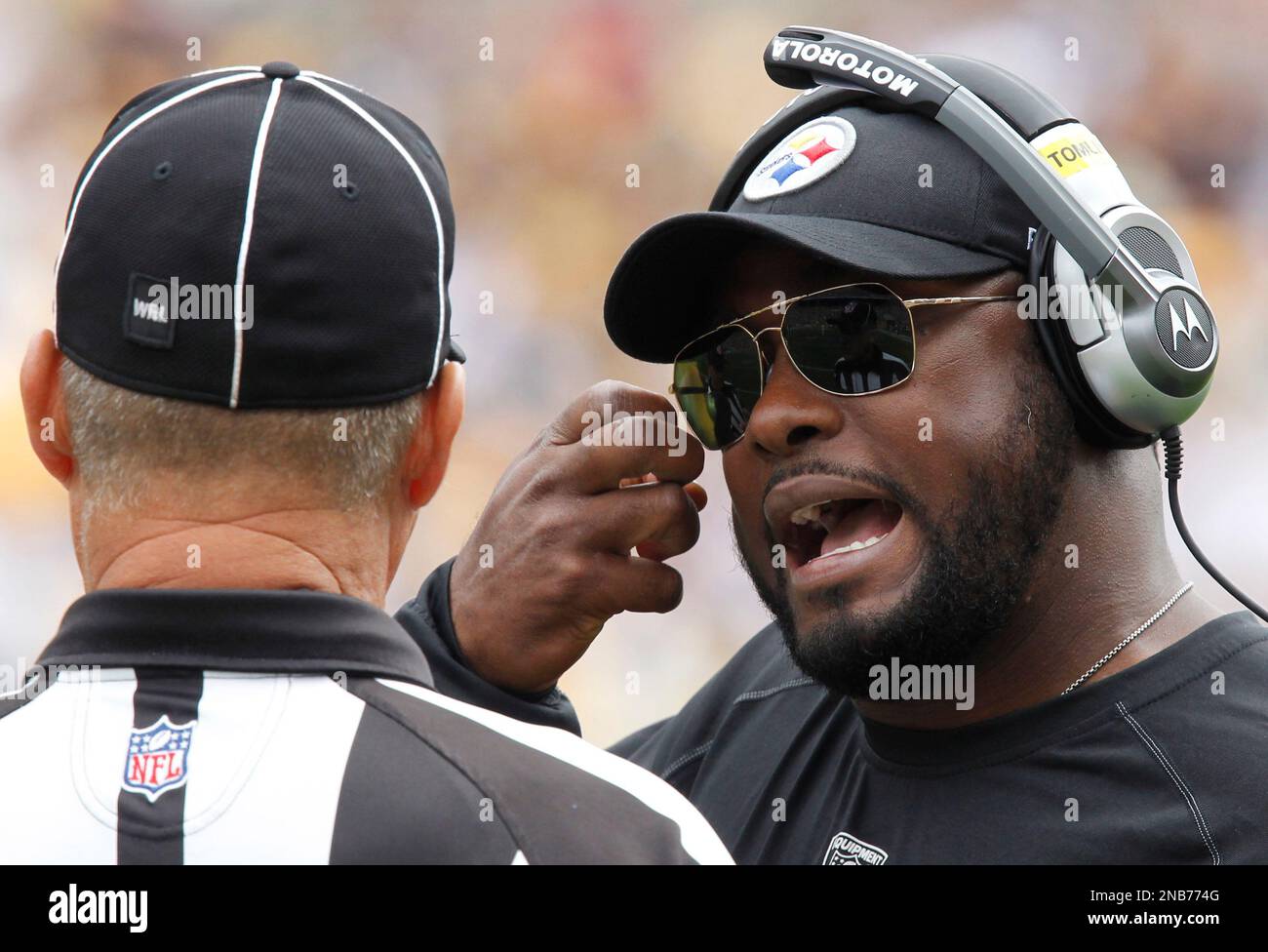 Pittsburgh Steelers coach Mike Tomlin talks with line judge Mark ...