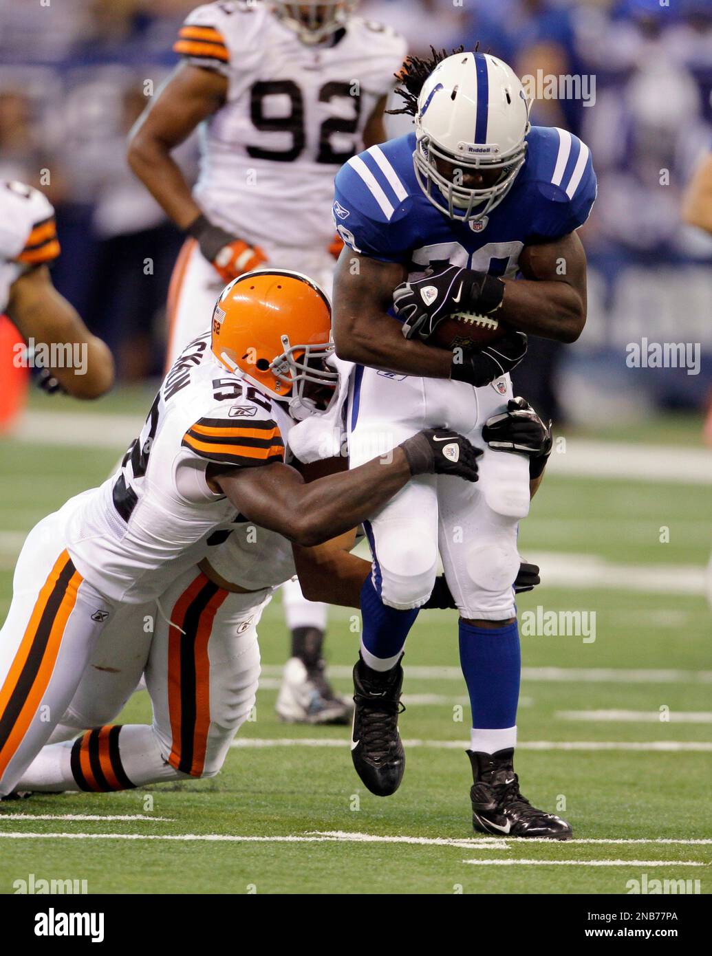 Indianapolis Colts running back Joseph Addai is tackled by Cleveland ...