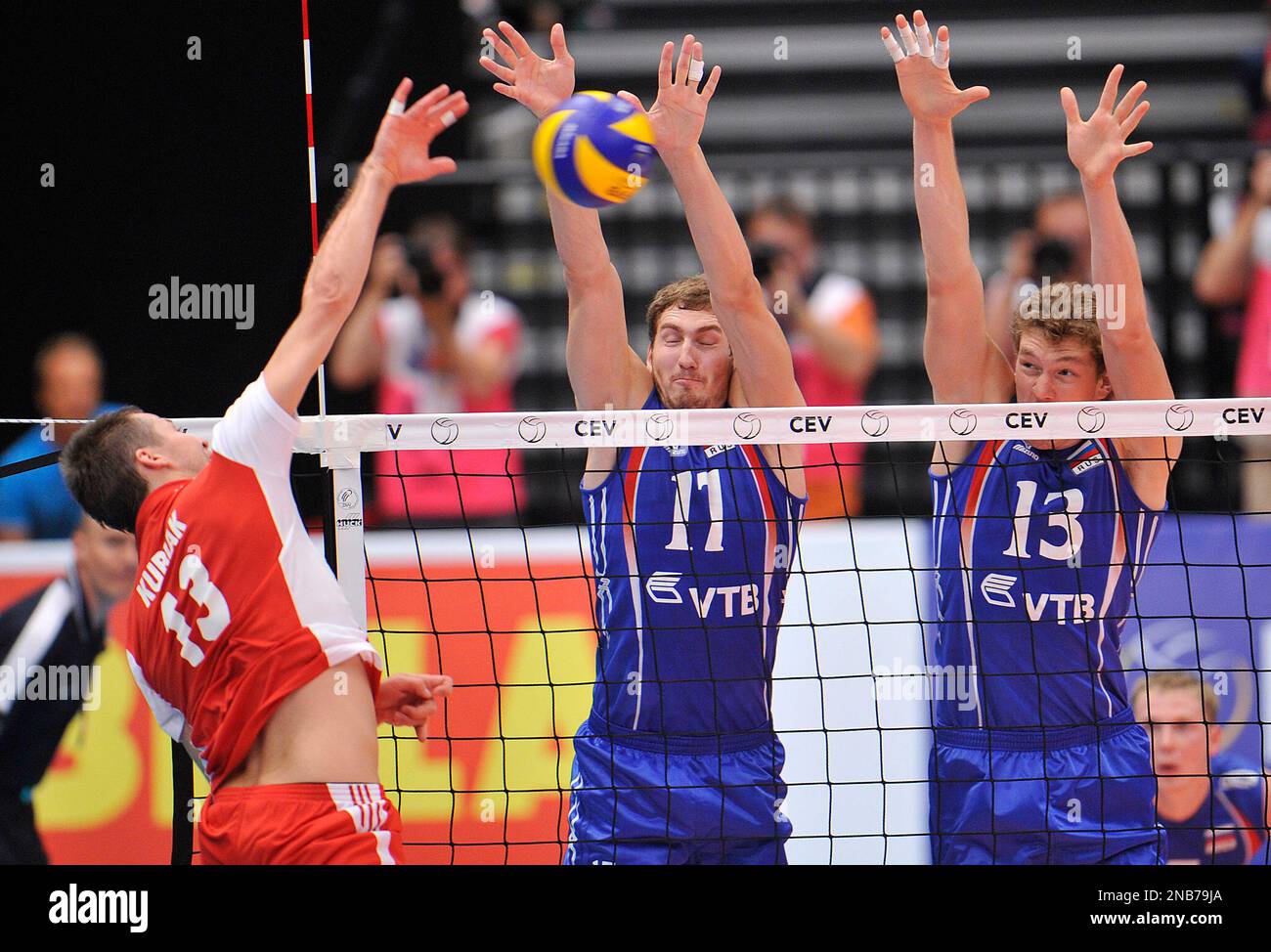 Russia's Dmitriy Muserskiy, right, and Maxim Mikhaylov, center, attempt to block a shot by ...