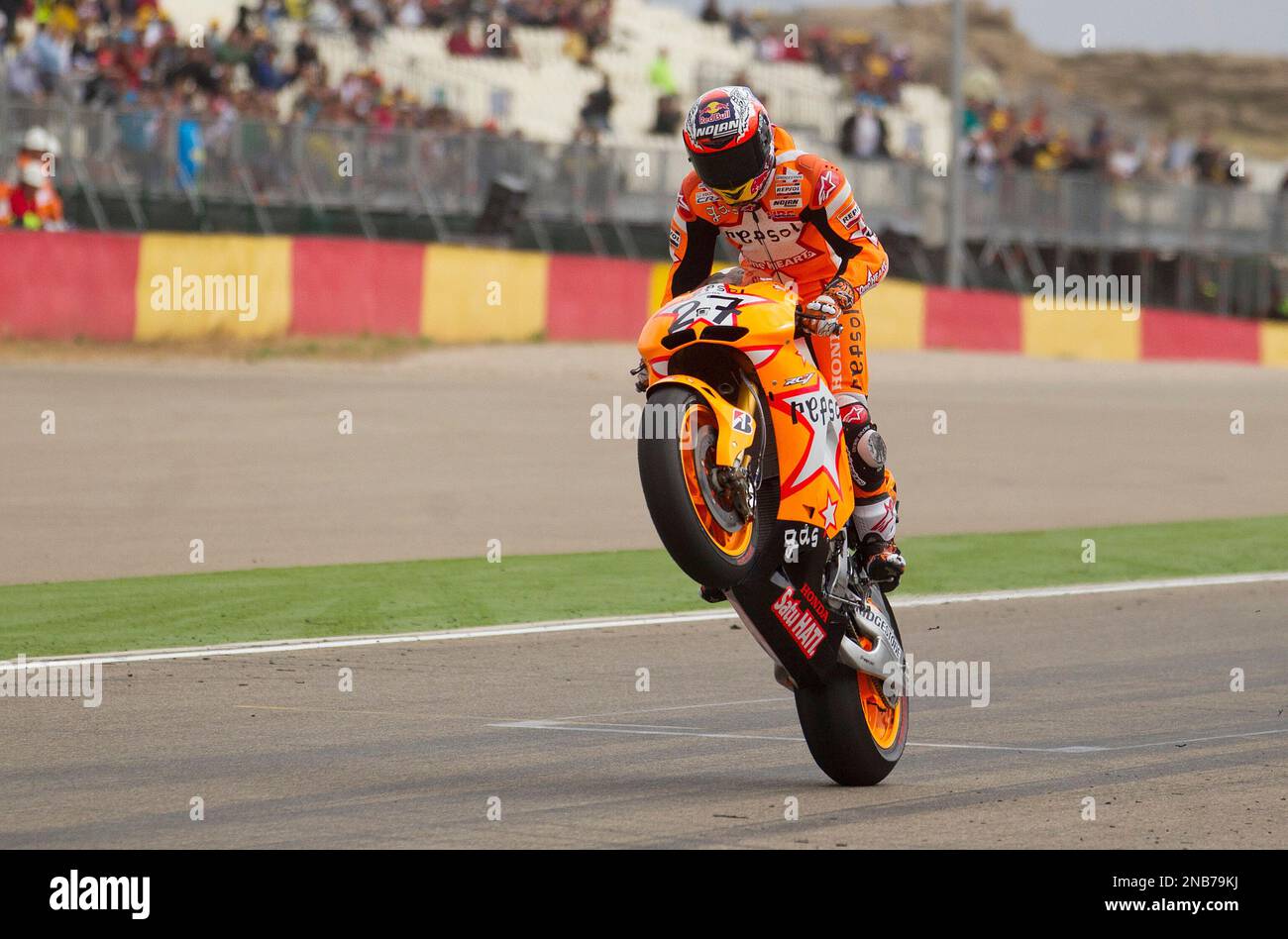 MotoGP Honda rider Casey Stoner of Australia does a wheelie as he ...