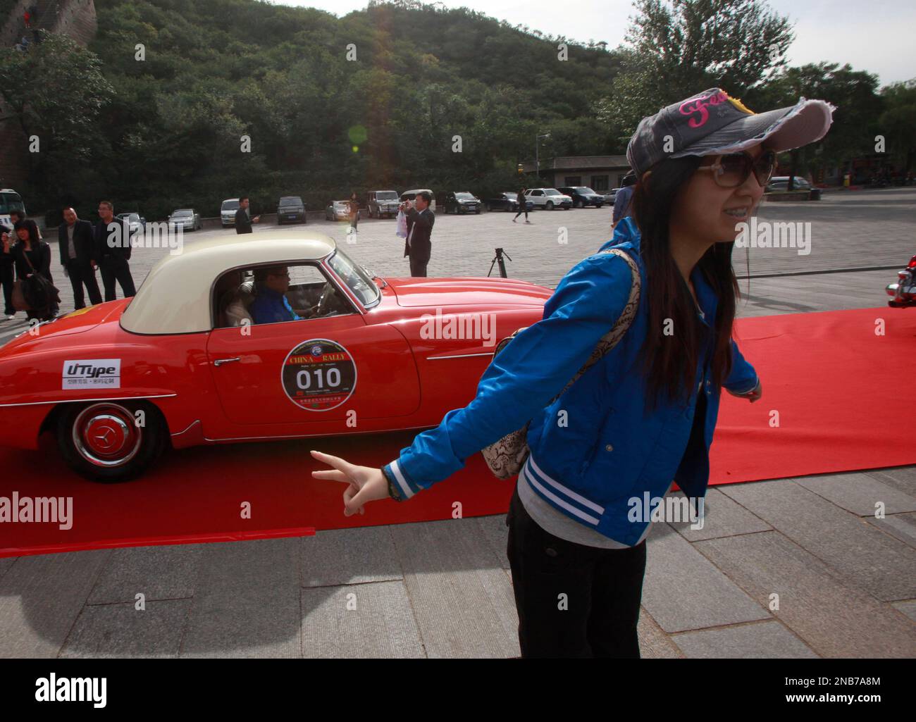 A Chinese girl poses for photos near a classic Mercedes Benz before the ...