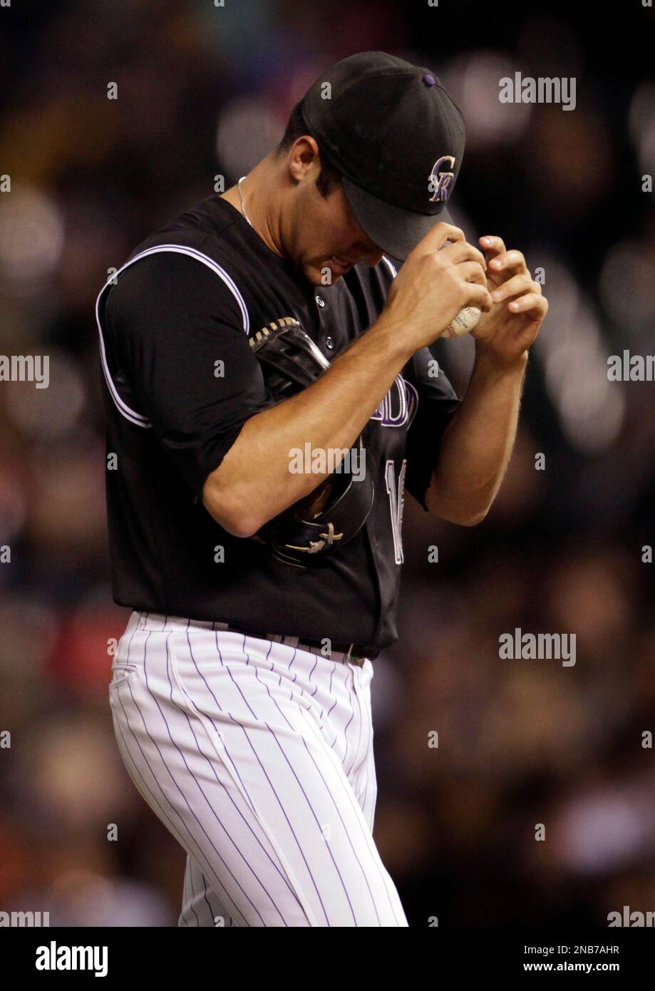 Colorado Rockies pitcher Huston Street adjusts his cap as he faces San ...